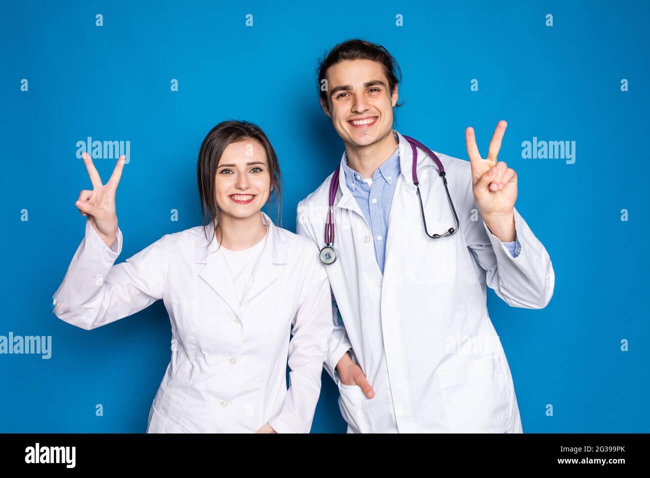 Medical team of doctors, man and woman with peace gesture isolated on ...
