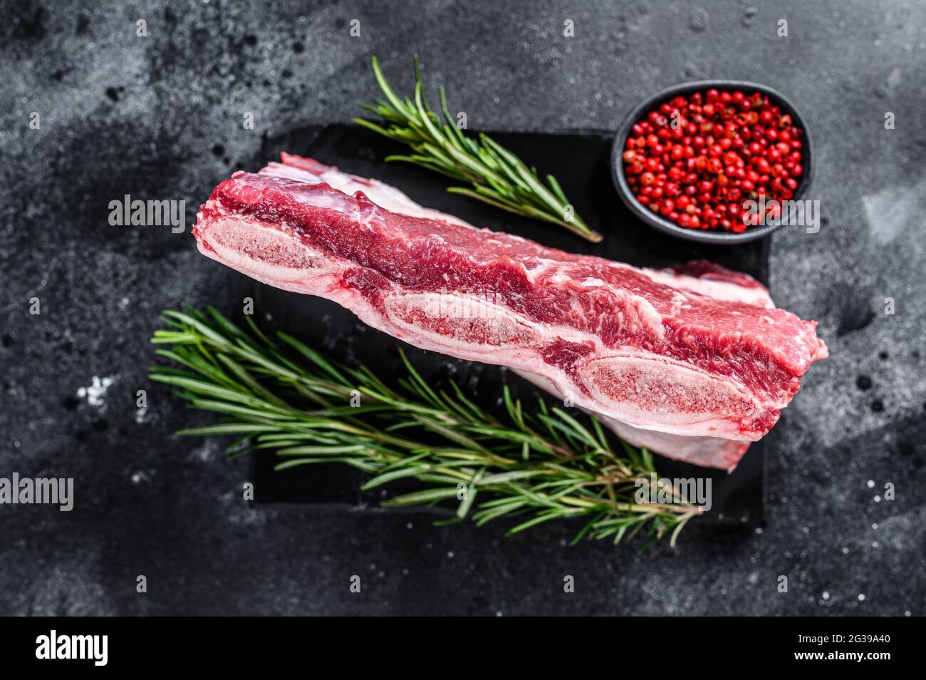 Raw beef short ribs kalbi on marble board. Black background. Top view ...