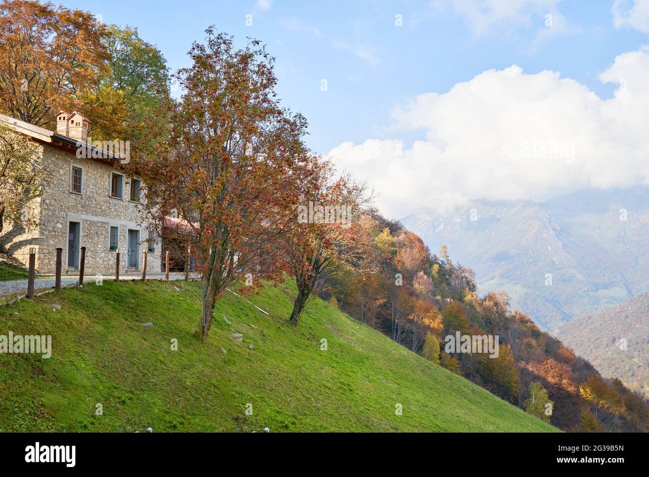 View on house on the mountain side, picturesque Alps autumn landscape ...