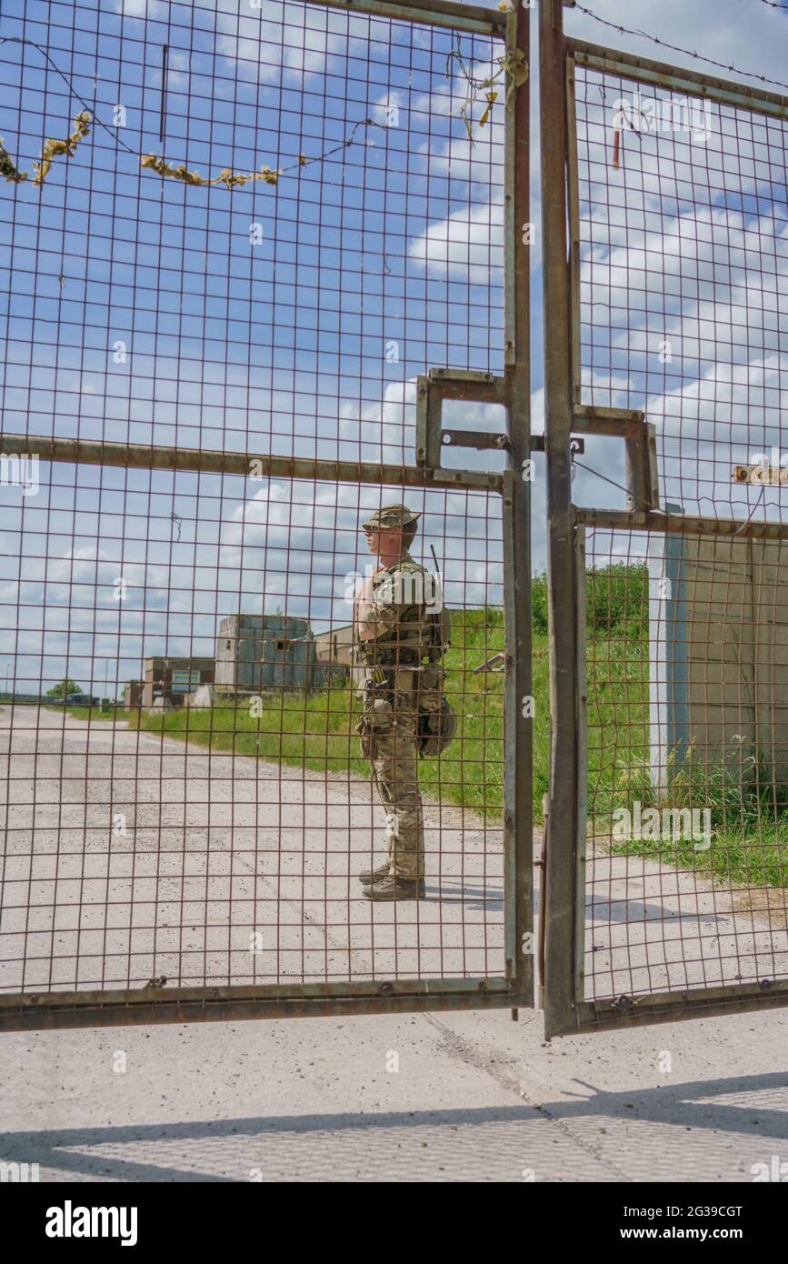 British Army soldier guarding the entrance to a secure base compound on ...