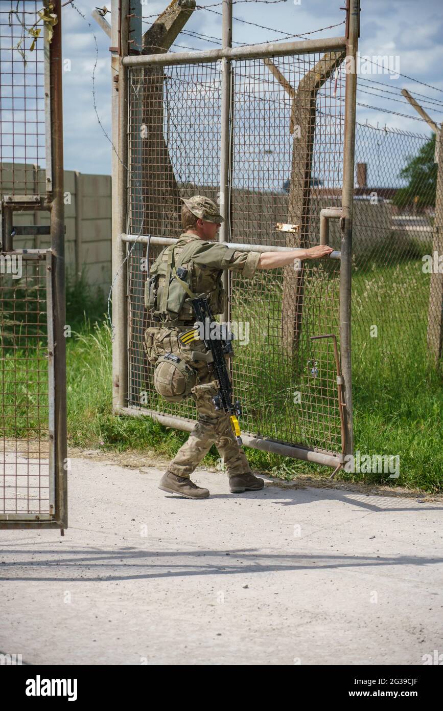 British Army soldier guarding the entrance to a secure base compound on ...