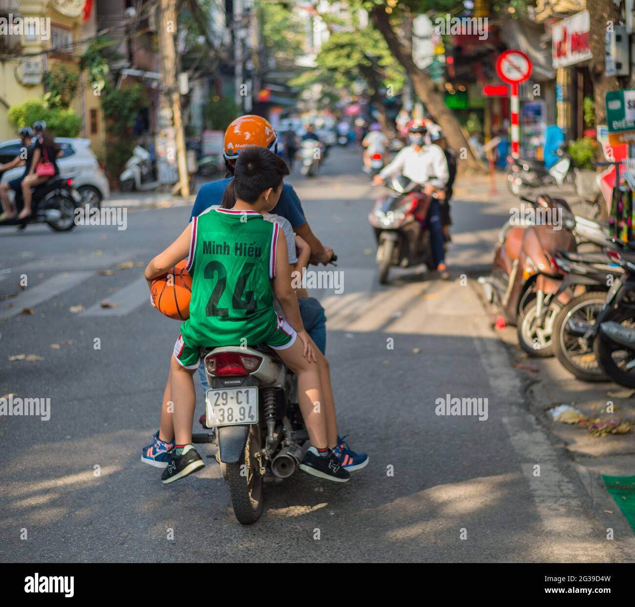Kids on a motorcycle carrying a basketball in Hanoi, Vietnam Stock ...