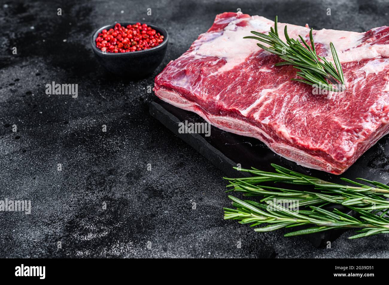 Raw beef short ribs kalbi on marble board. Black background. Top view ...