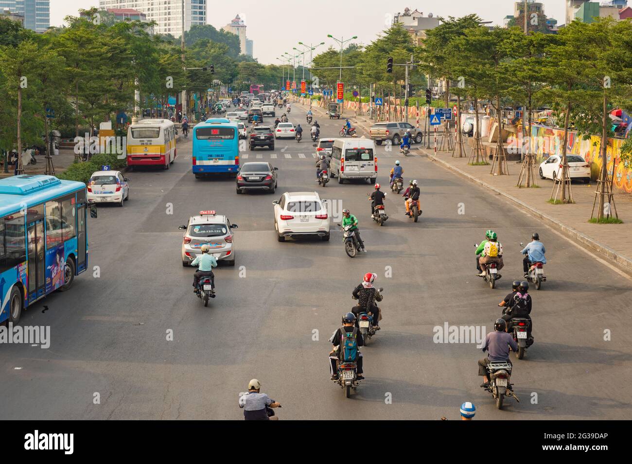 A busy road with cars buses and motorcycles with a motorcyclist going ...