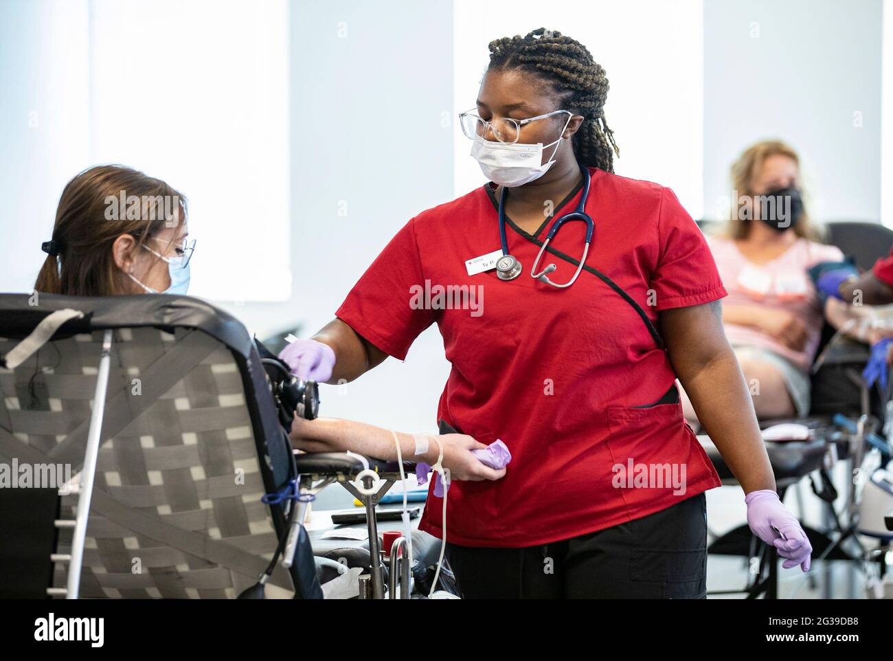 Chicago, USA. 14th June, 2021. A Red Cross worker helps a woman to ...