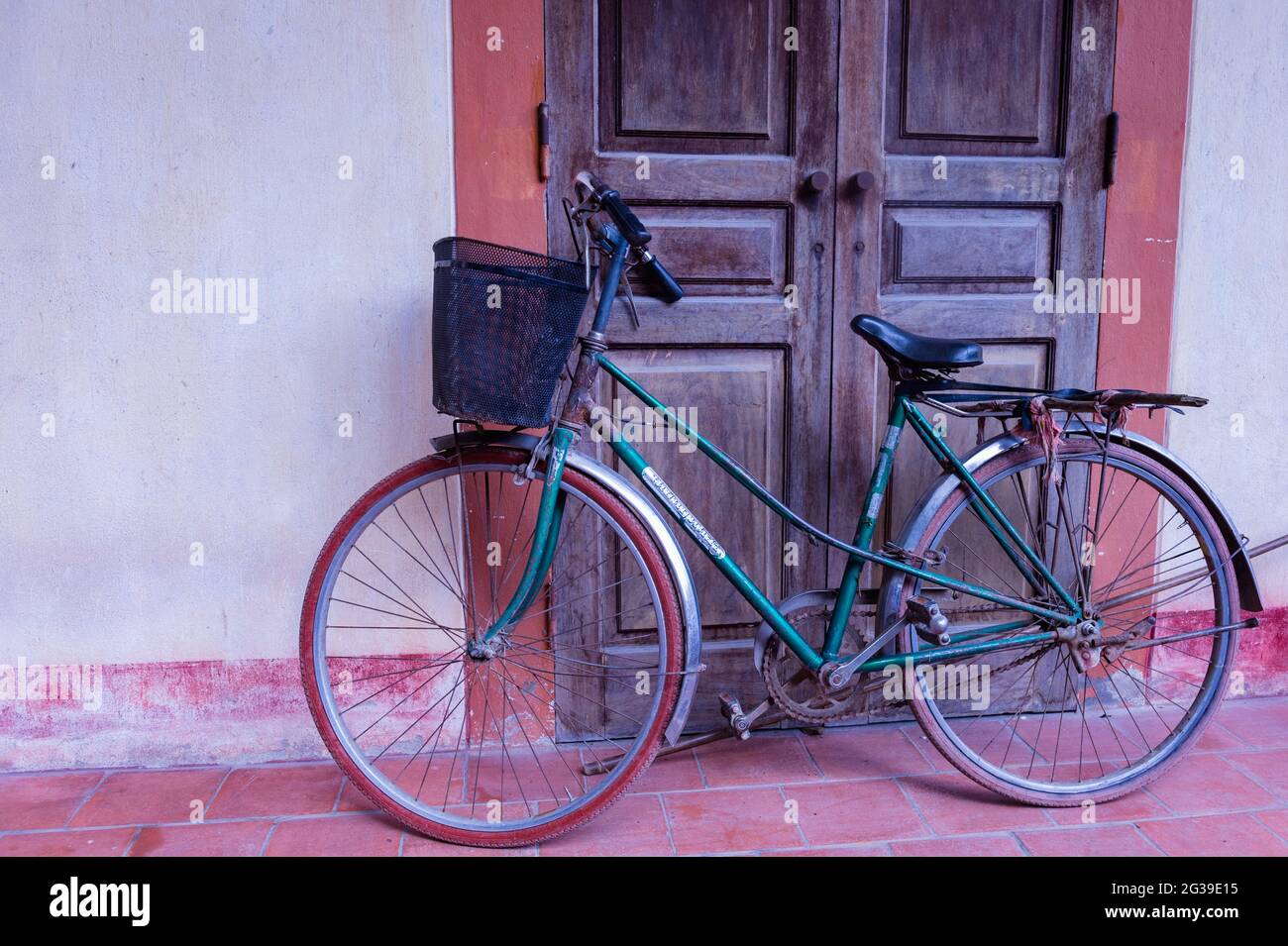 An old vintage style bicycle against two aged wooden doors Stock Photo ...