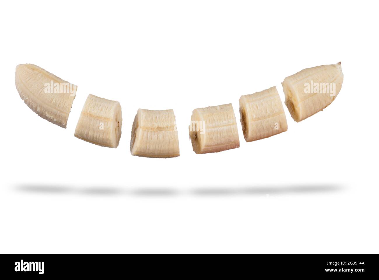 Peeled banana cut in portions on white background Stock Photo - Alamy