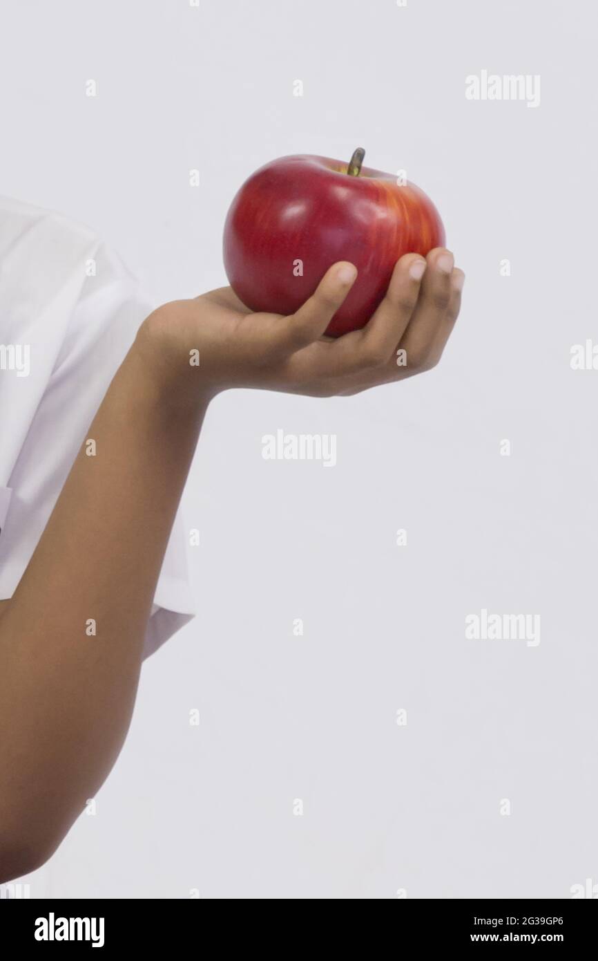 hand with apple on white background Stock Photo - Alamy