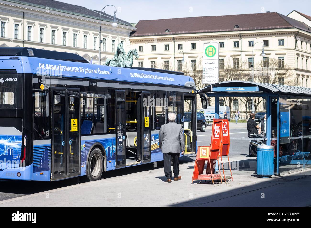 MUNICH, GERMANY - Jun 12, 2021: A man is entering a bus at a bus stop ...