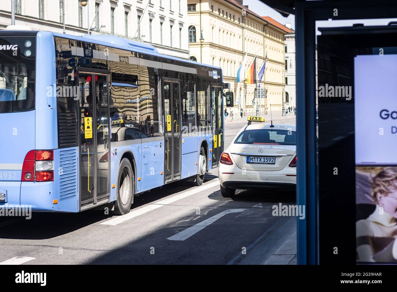MUNICH, GERMANY - Jun 12, 2021: bus and taxi are standing next to each ...