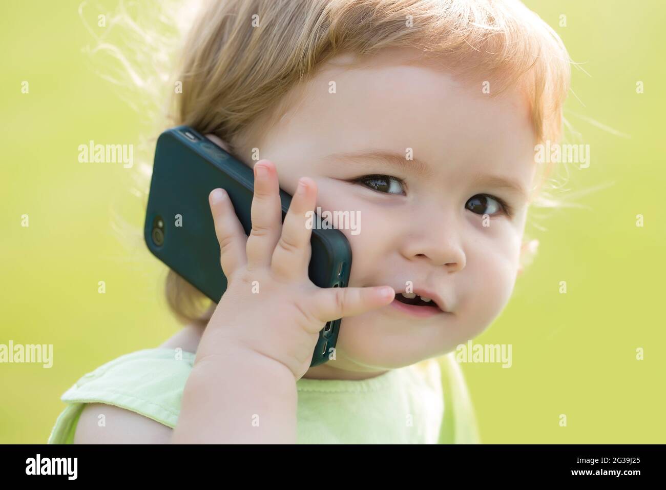 Small baby boy speaking on phone Stock Photo - Alamy