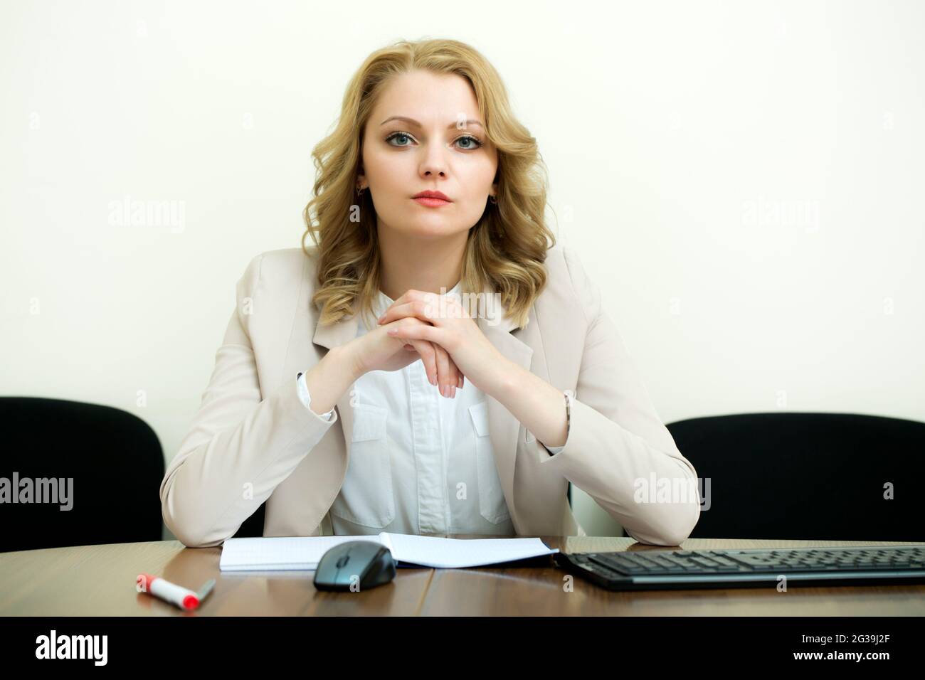 Pretty business woman at table Stock Photo - Alamy