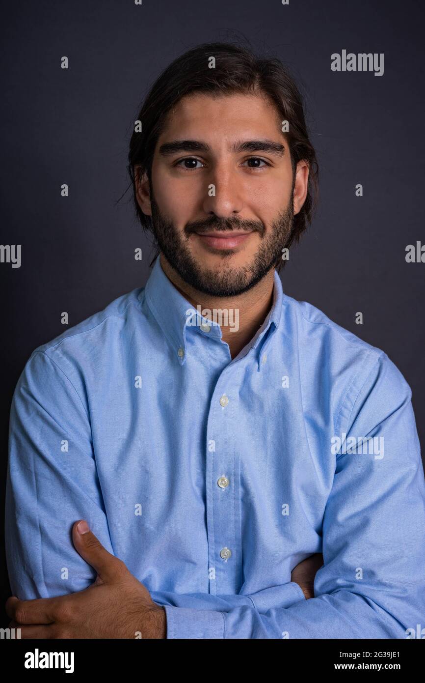 Studio Portrait of Hispanic Man with Beard and Long Hair in Blue Shirt ...
