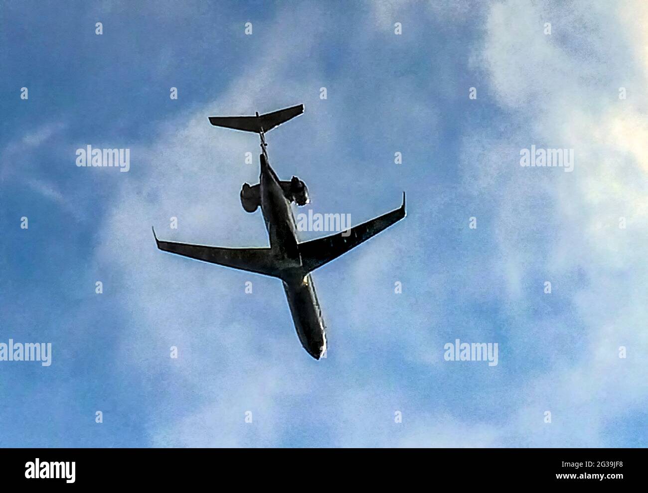 Passenger jet soars overhead Stock Photo - Alamy