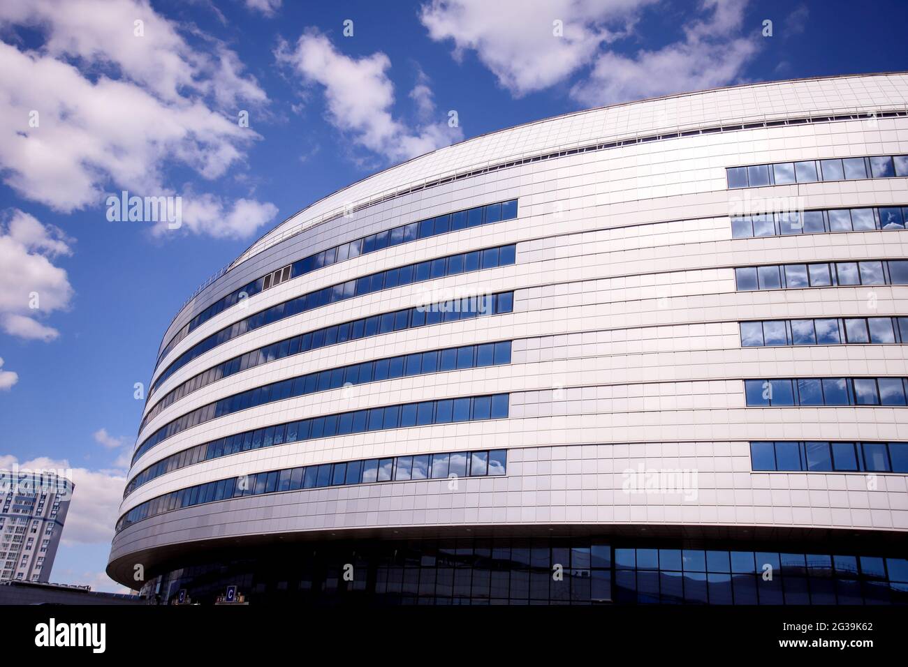The new building of the sports complex against the blue sky. Glass ...