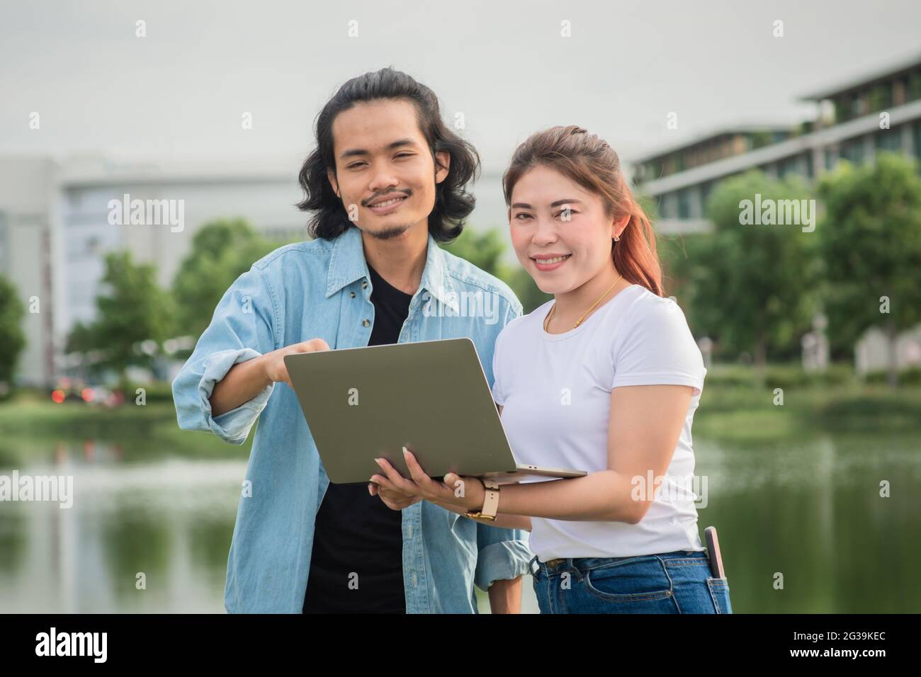 Two business people happy using computer technology outdoor Stock Photo ...
