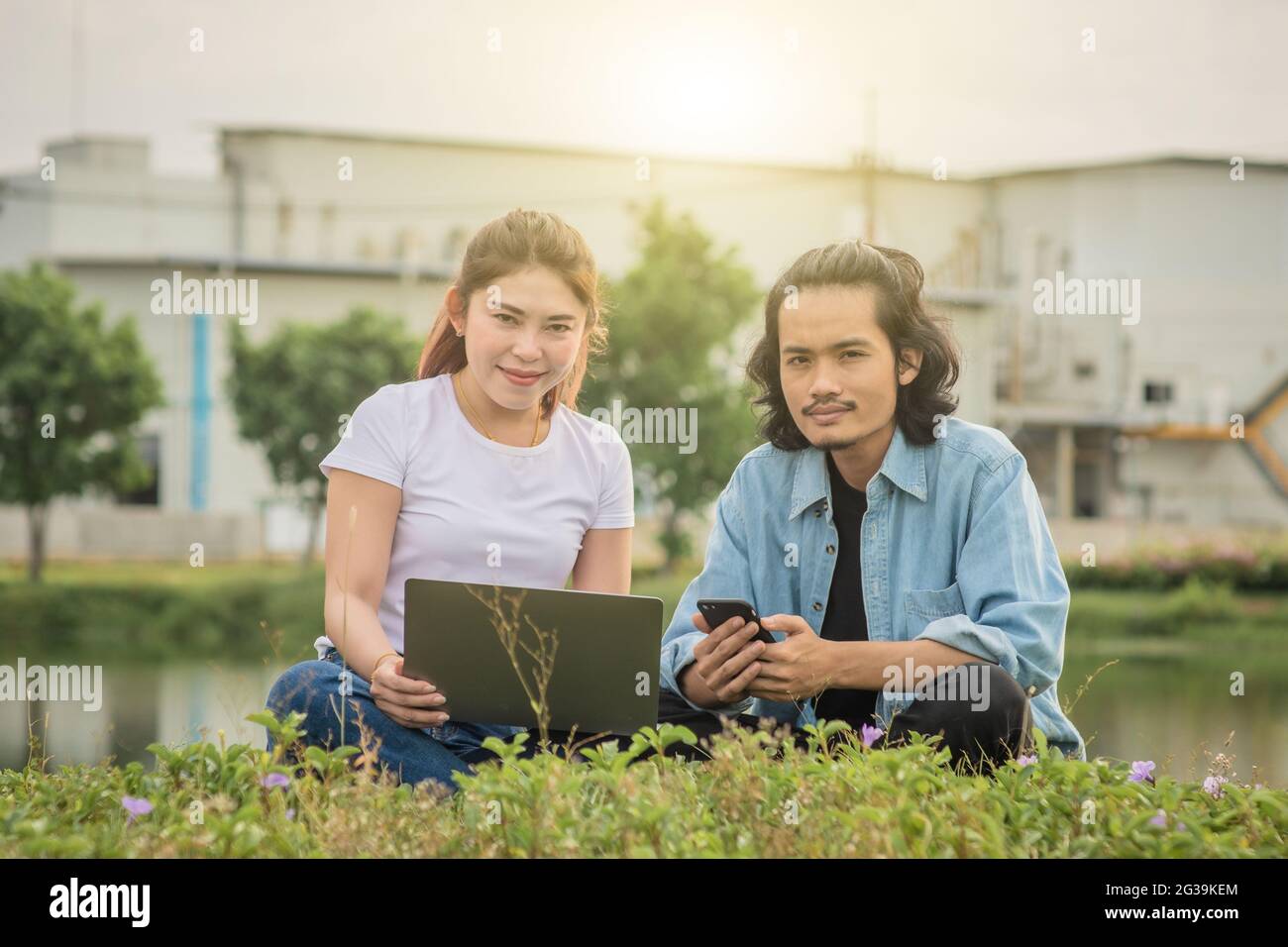 Asian people sitting outdoor using computer city park Stock Photo - Alamy