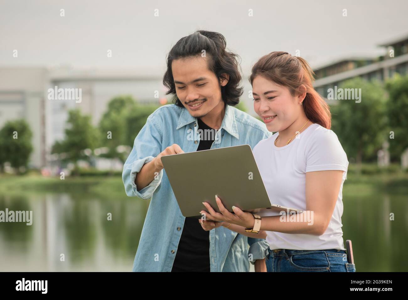 Two business people happy using computer technology outdoor Stock Photo ...