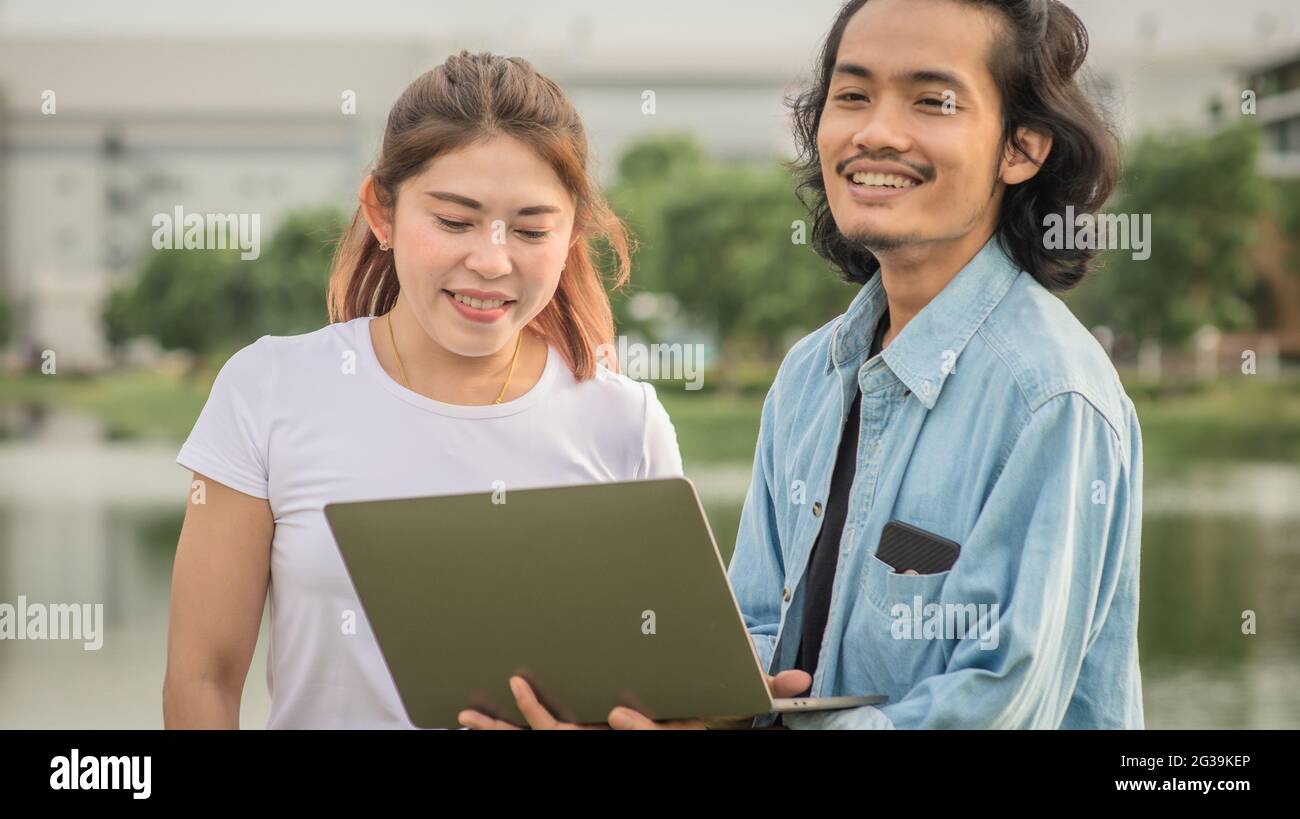 Cheerful partners using computer together hi-res stock photography and ...