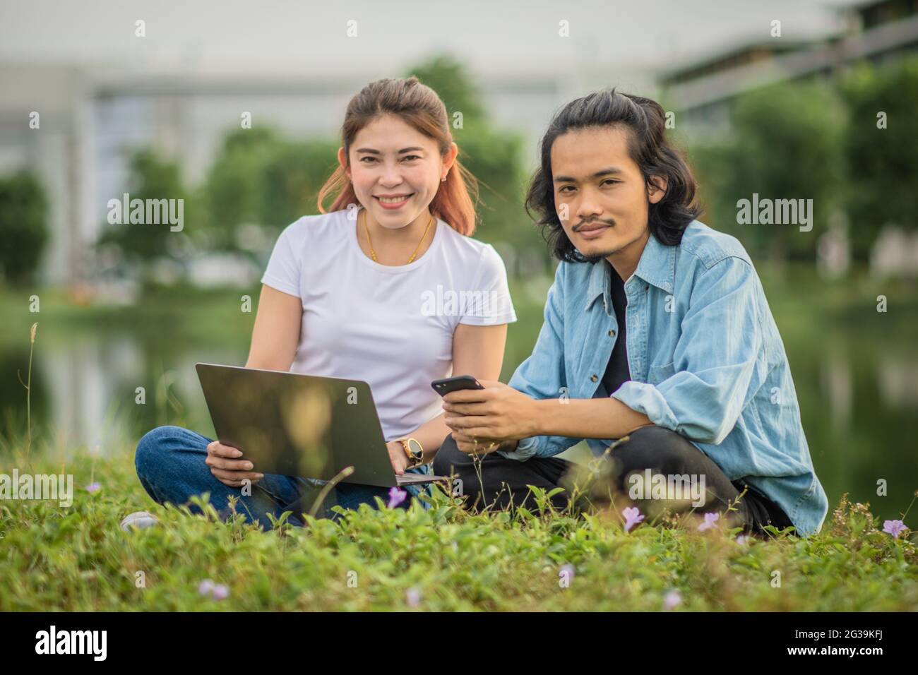 Asian people sitting outdoor using computer city park Stock Photo - Alamy