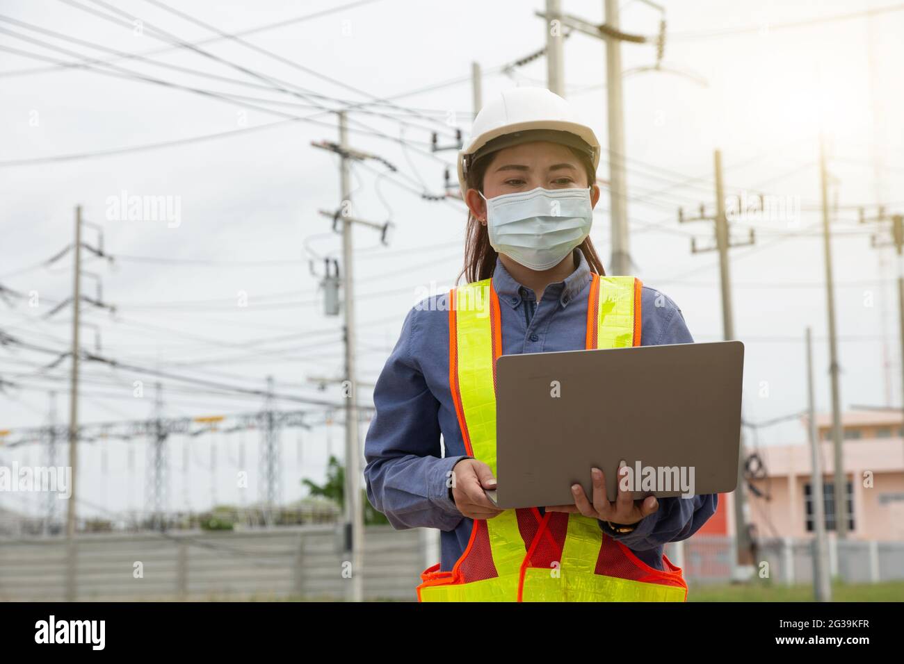 Female Engineer holding laptop working outdoor. Worker Woman use ...