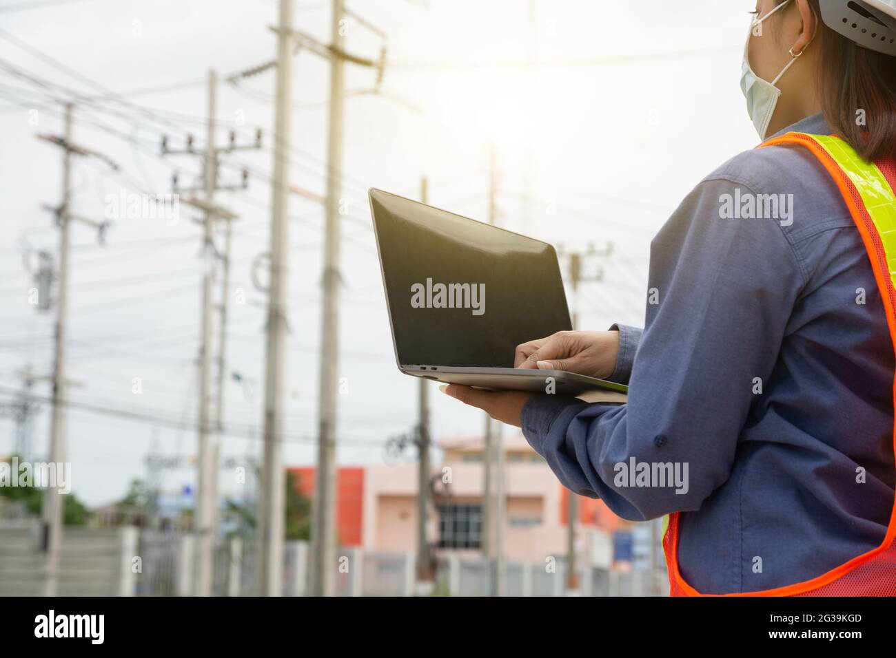 Female Engineer holding laptop working outdoor. Worker Woman use ...