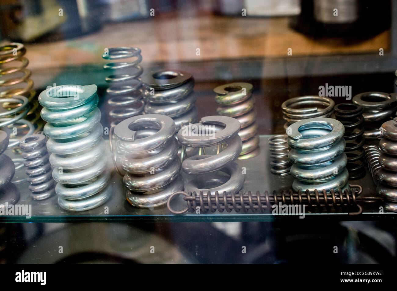 Springs displayed behind glass Stock Photo - Alamy