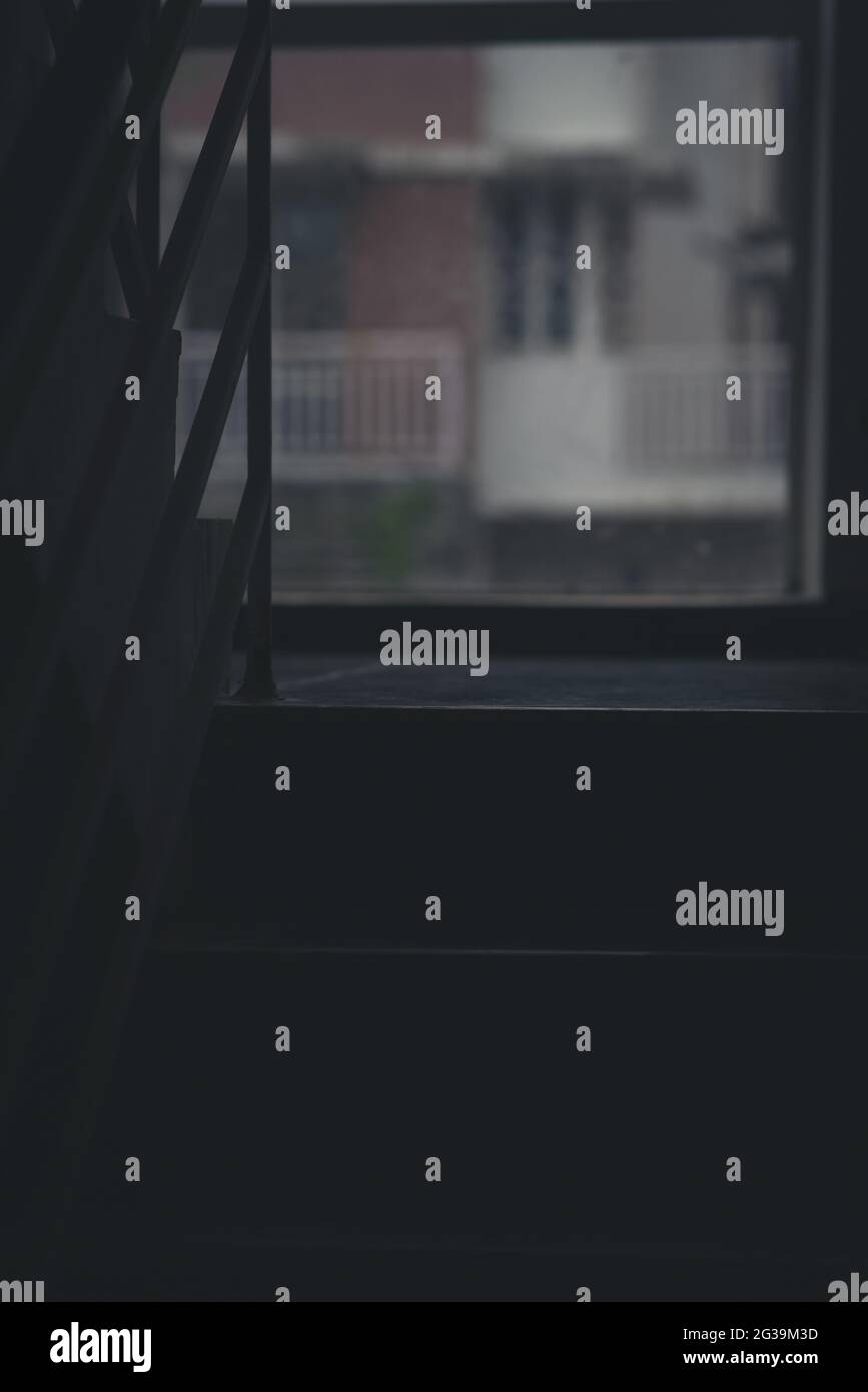 Vertical shot of a staircase leading to the window Stock Photo - Alamy