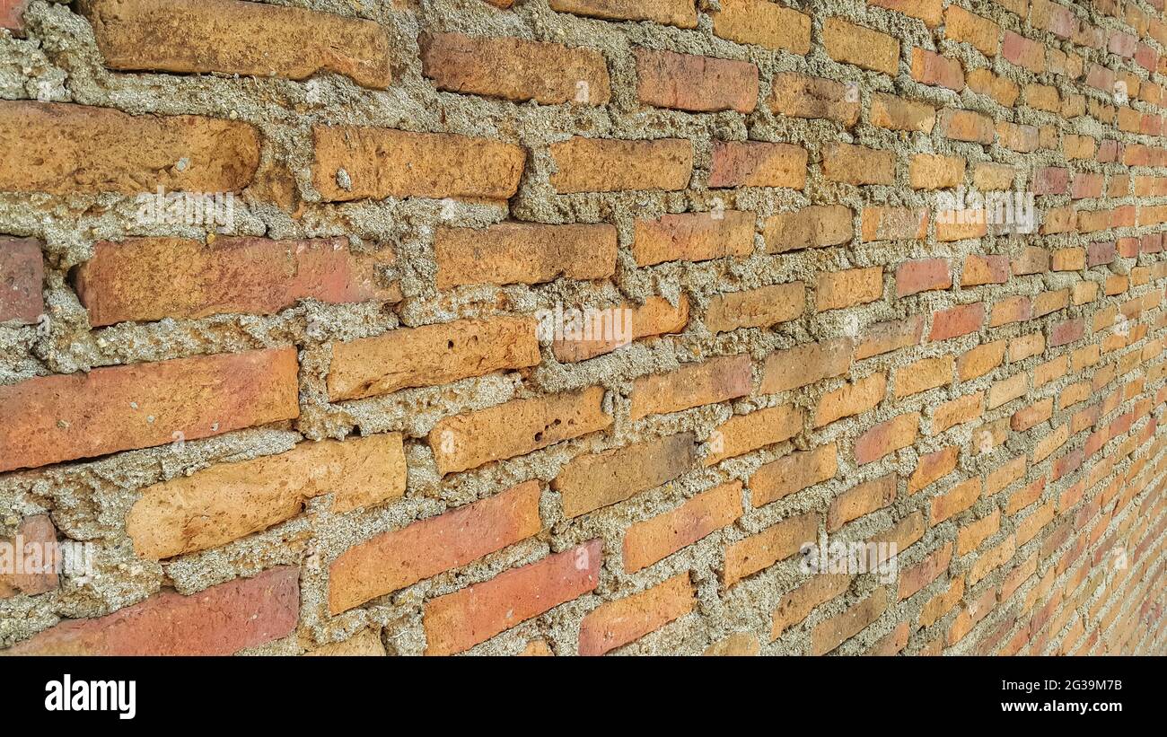 Side view of old orange vintage brick wall background Stock Photo - Alamy