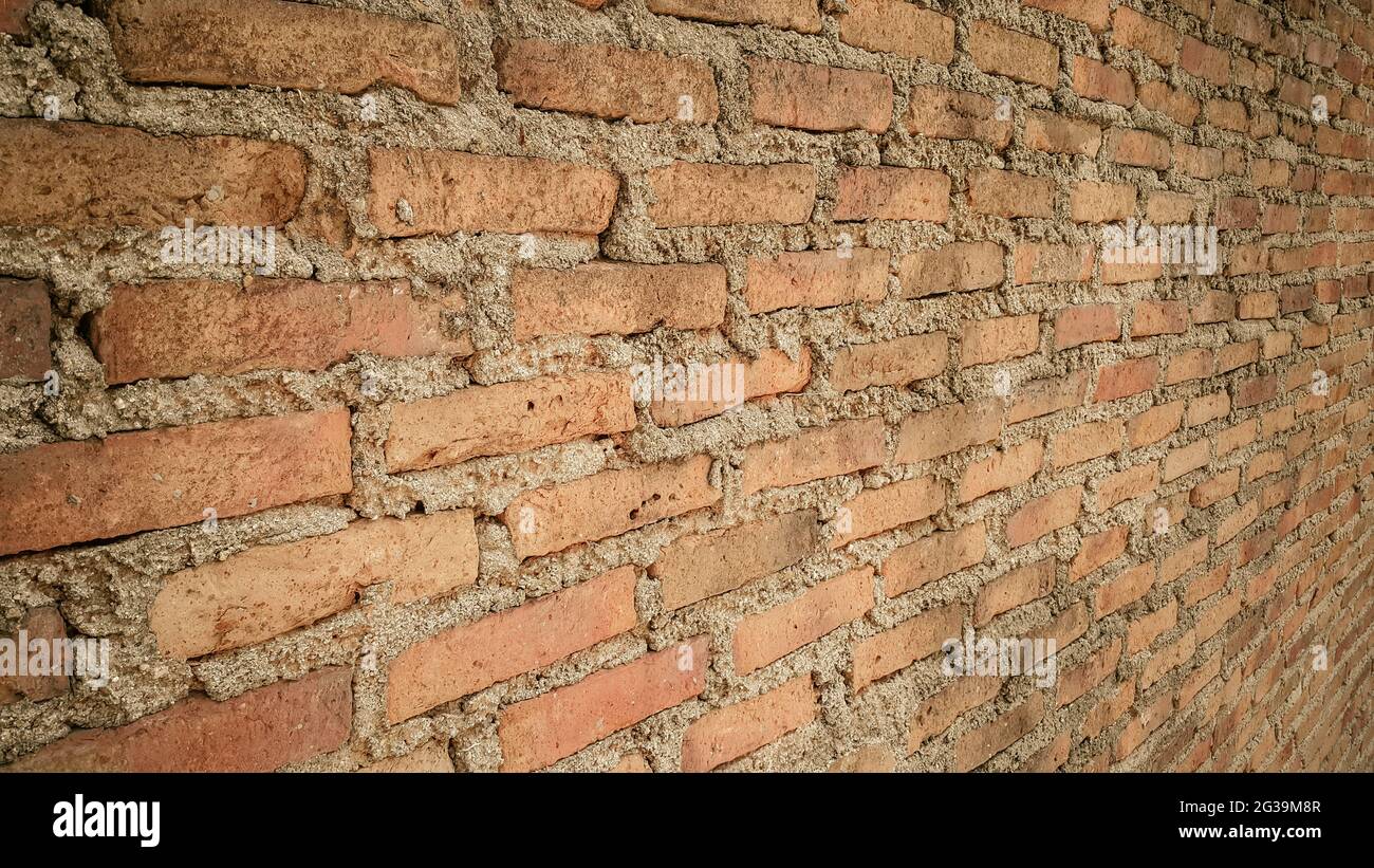 Side view of old orange vintage brick wall background Stock Photo - Alamy