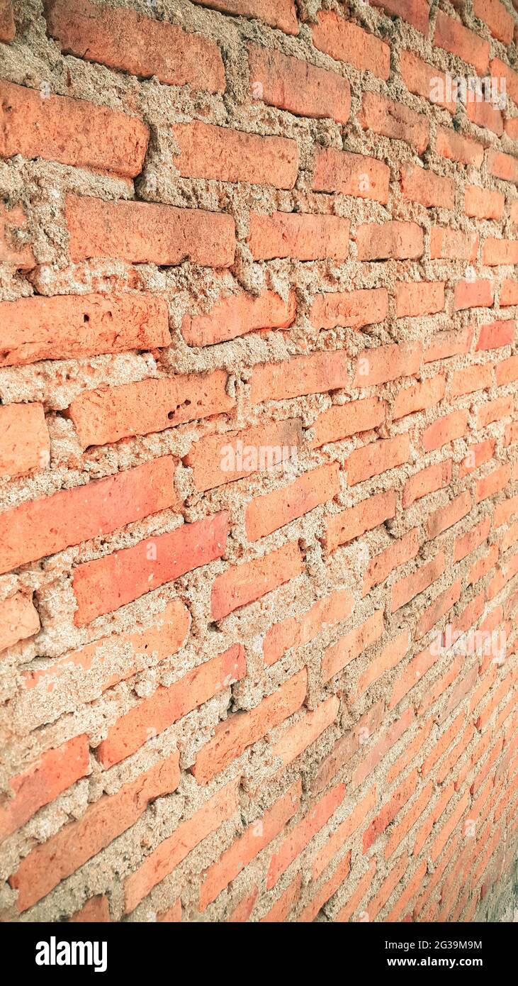 Side view of old orange vintage brick wall background Stock Photo - Alamy