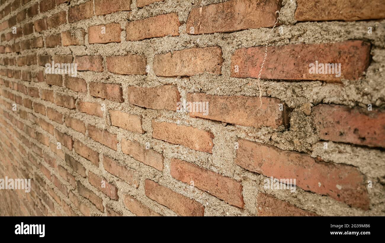 Side view of old orange vintage brick wall background Stock Photo - Alamy