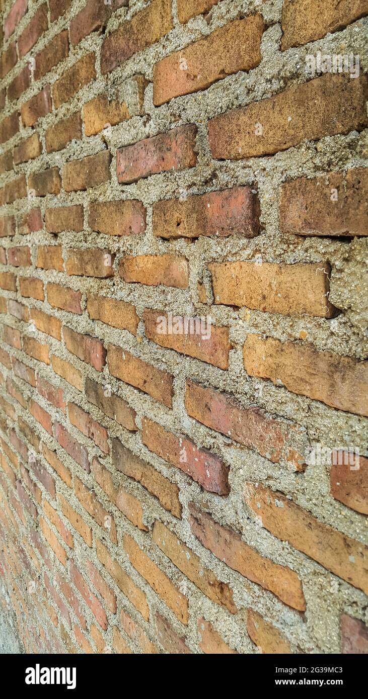 Side view of old orange vintage brick wall background Stock Photo - Alamy