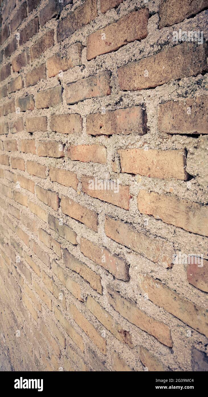 Side view of old orange vintage brick wall background Stock Photo - Alamy