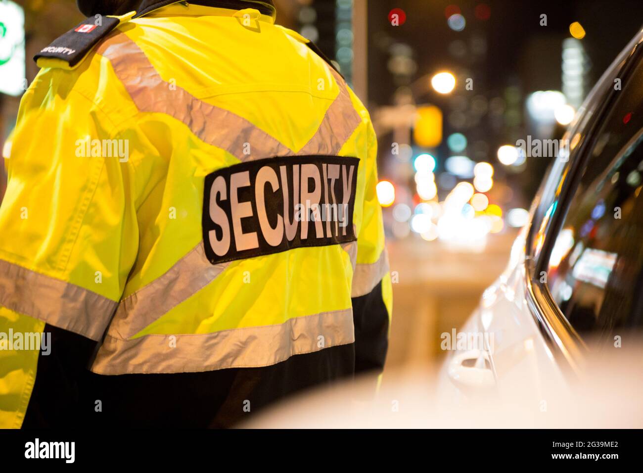 Security guard walking through street of the big city at night Stock ...