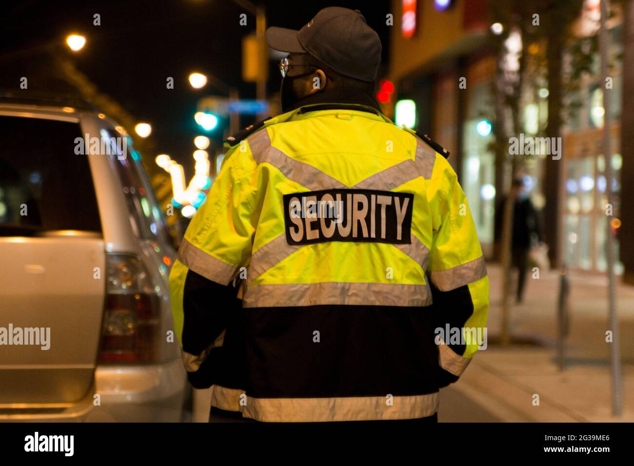 Security guard walking through street of the big city at night Stock ...
