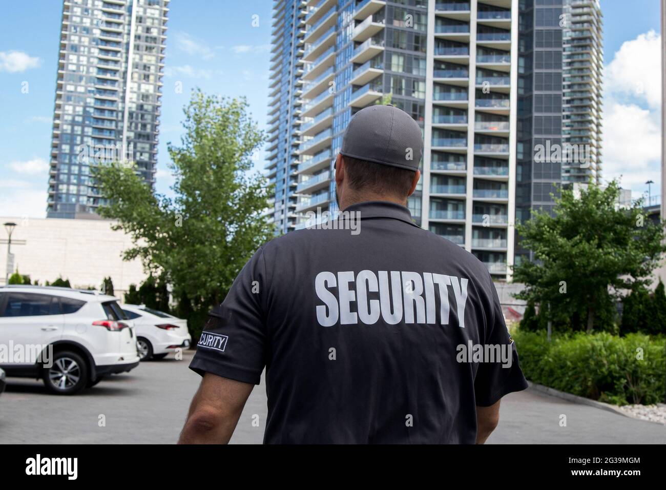 Security guard in uniform patrolling a residential area Stock Photo - Alamy