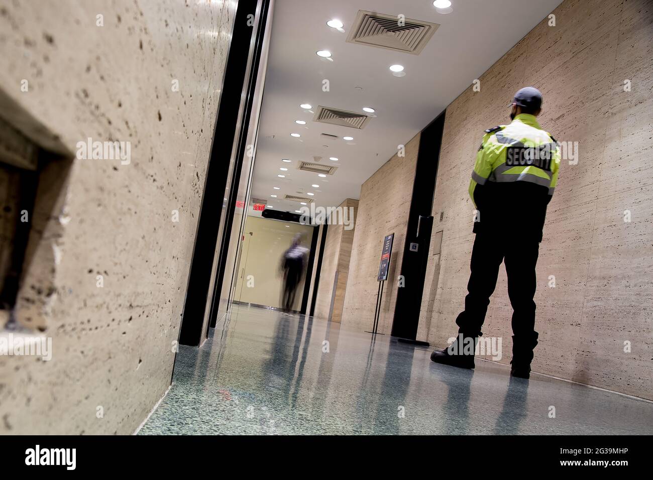 Low angle shot of security guards patrolling inside commercial b Stock ...