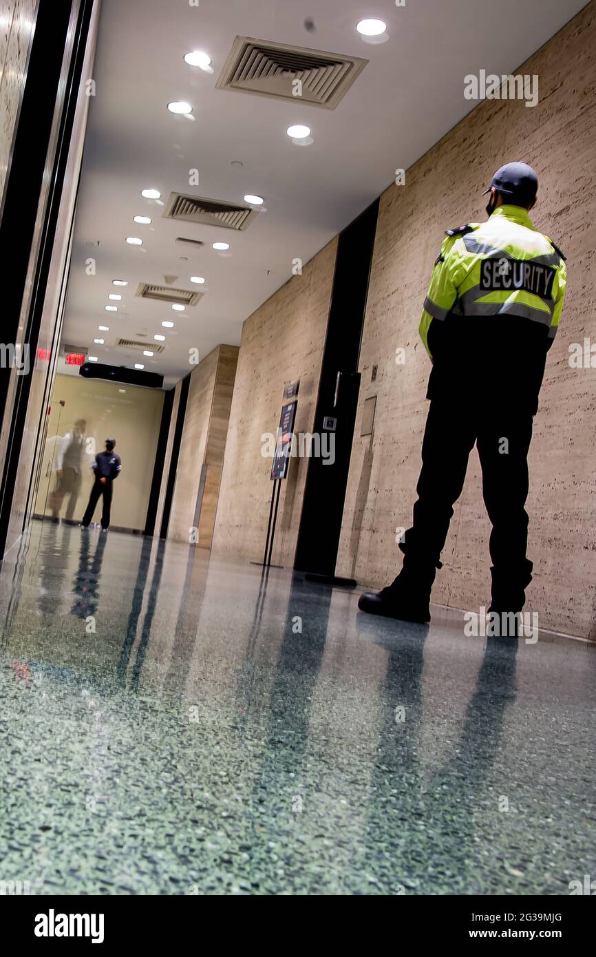 Low angle shot of security guards patrolling inside commercial b Stock ...