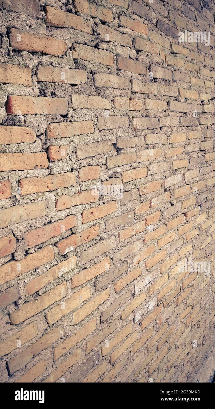 Side view of old orange vintage brick wall background Stock Photo - Alamy