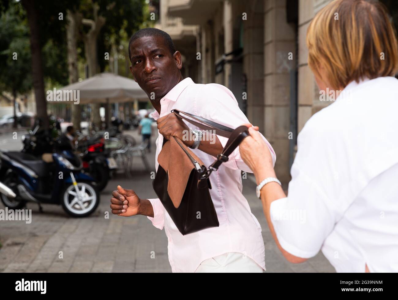 Bag snatching hi-res stock photography and images - Alamy