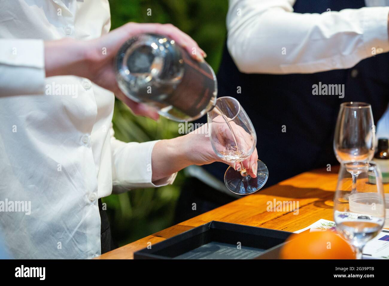 Bar staff pouring gin during a gin tasting experience Stock Photo - Alamy