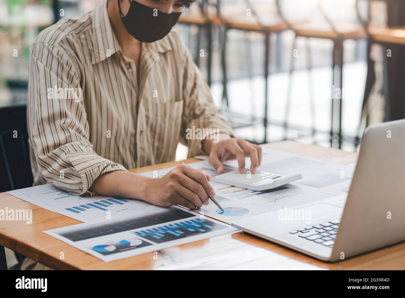 Businessman or accountant wear mask working on desk office with using a ...