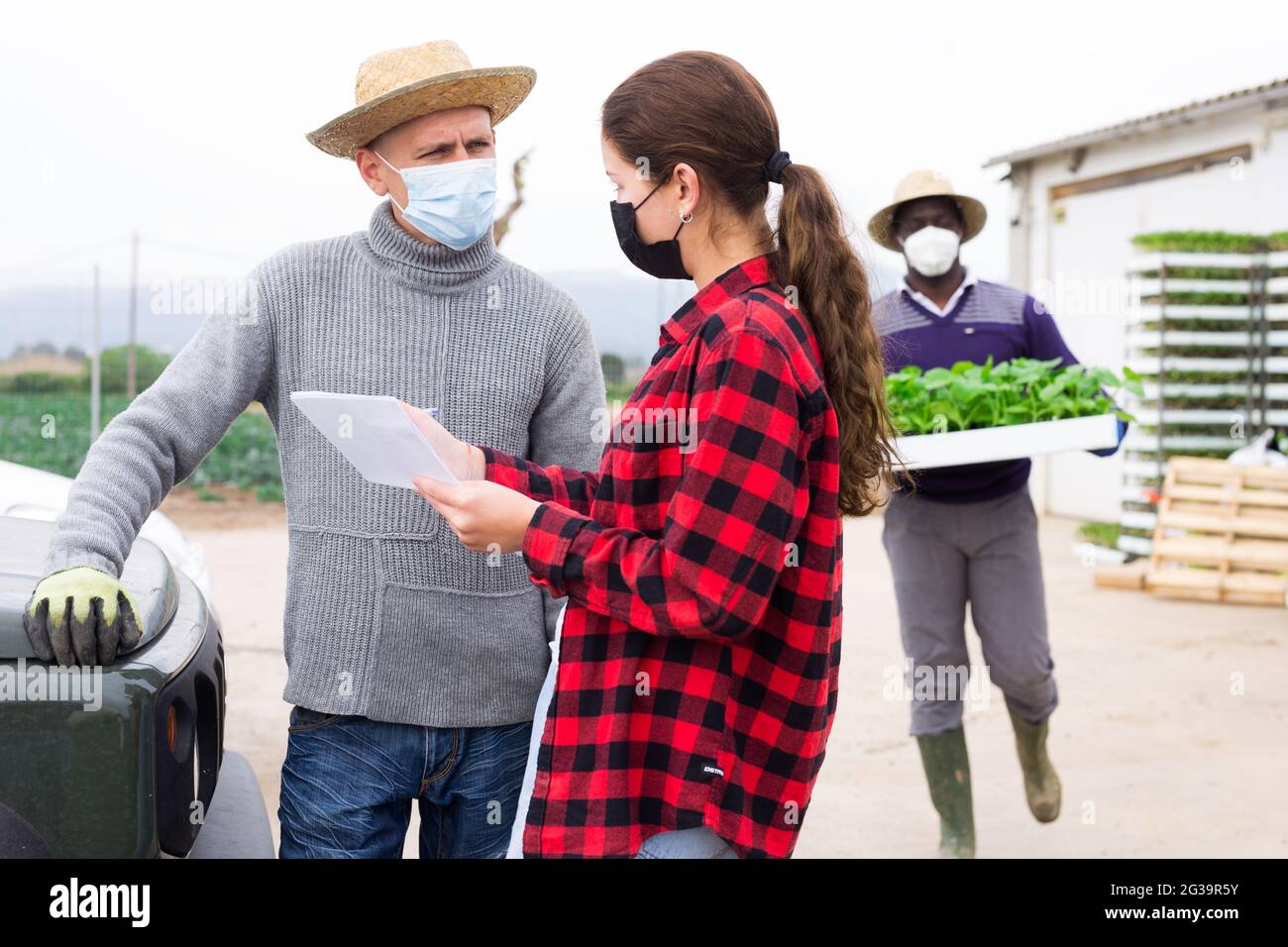 Farmers talking near car at plant nursery Stock Photo - Alamy