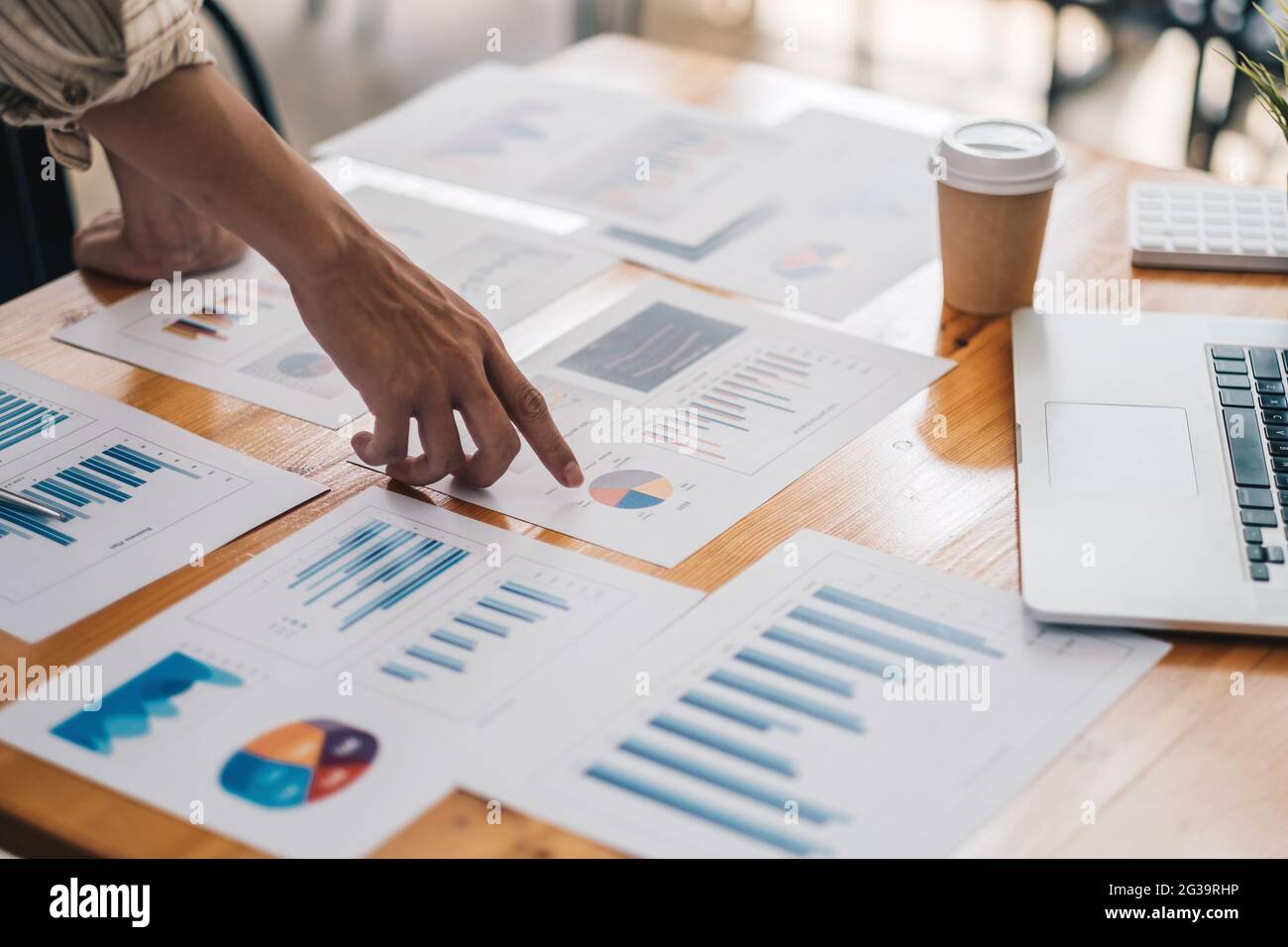 Businessman discussing analysis charts or graphs on desk table and ...