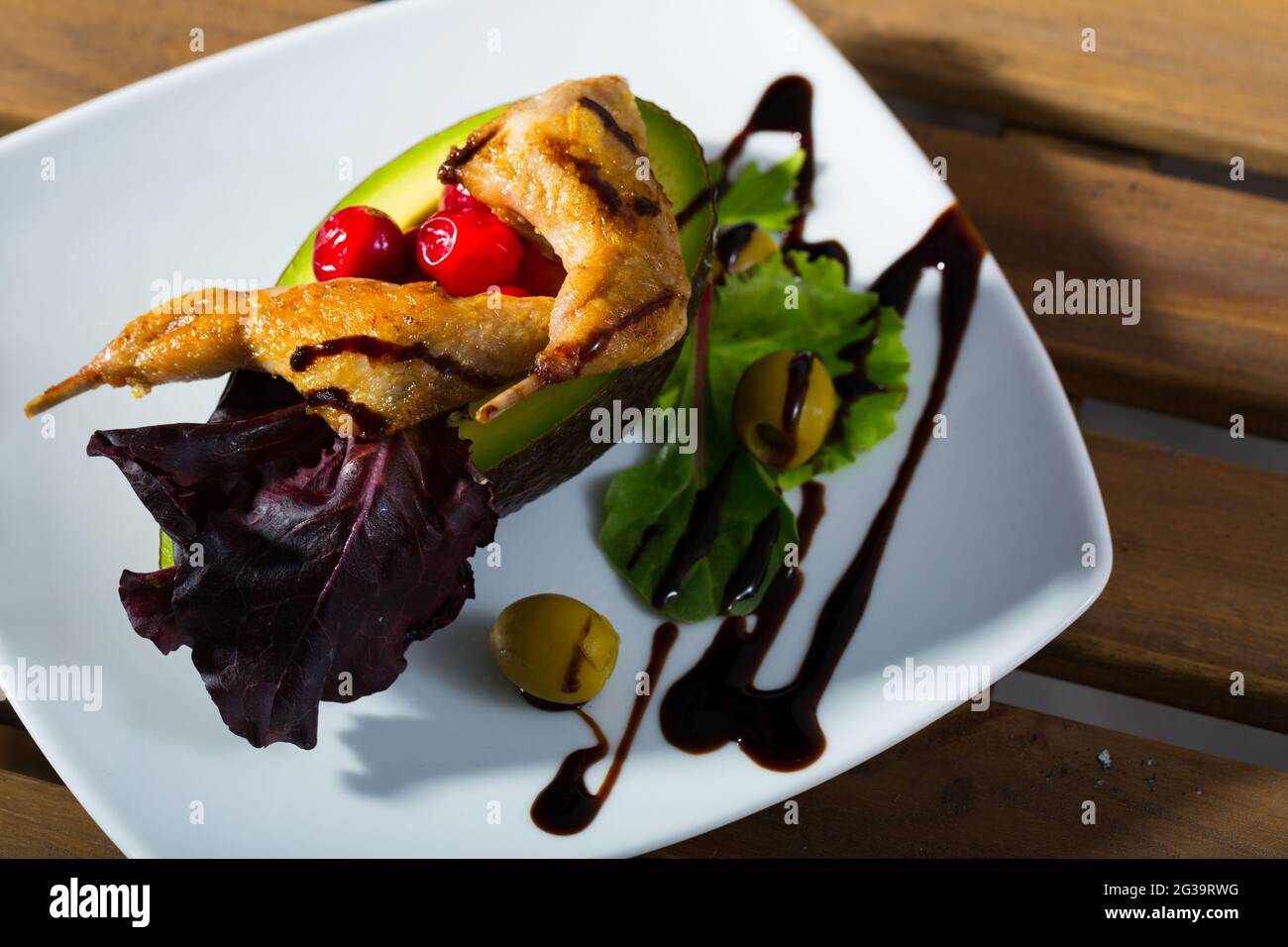 Delicious fried legs of quail with balsamic pasta, avocado and greens ...