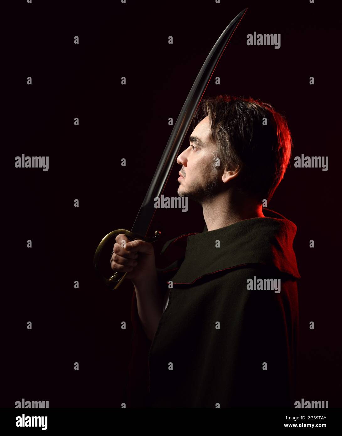 Profile, portrait of adult man warrior in cape standing sideways ...