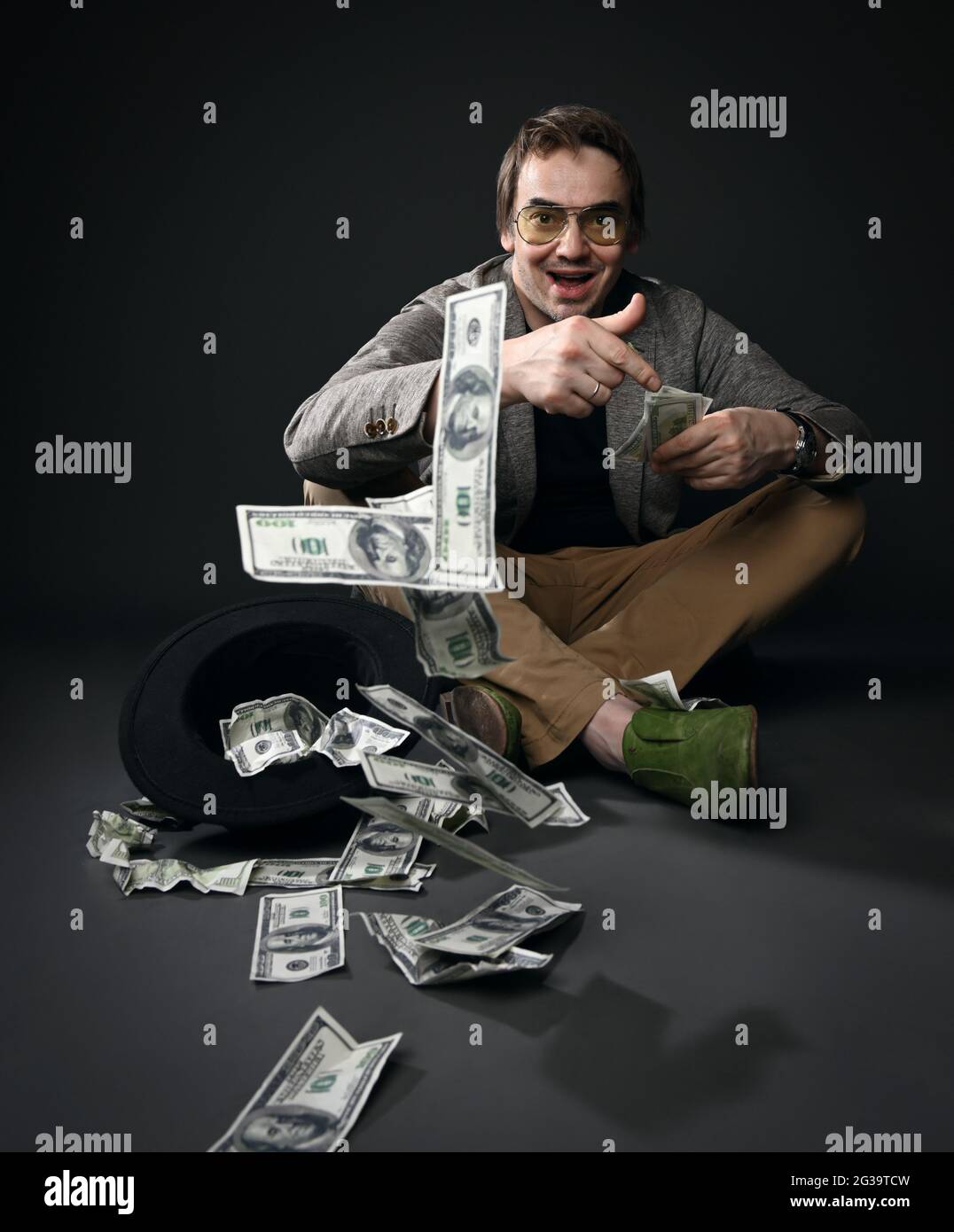 Happy rich man throwing money hi-res stock photography and images - Alamy
