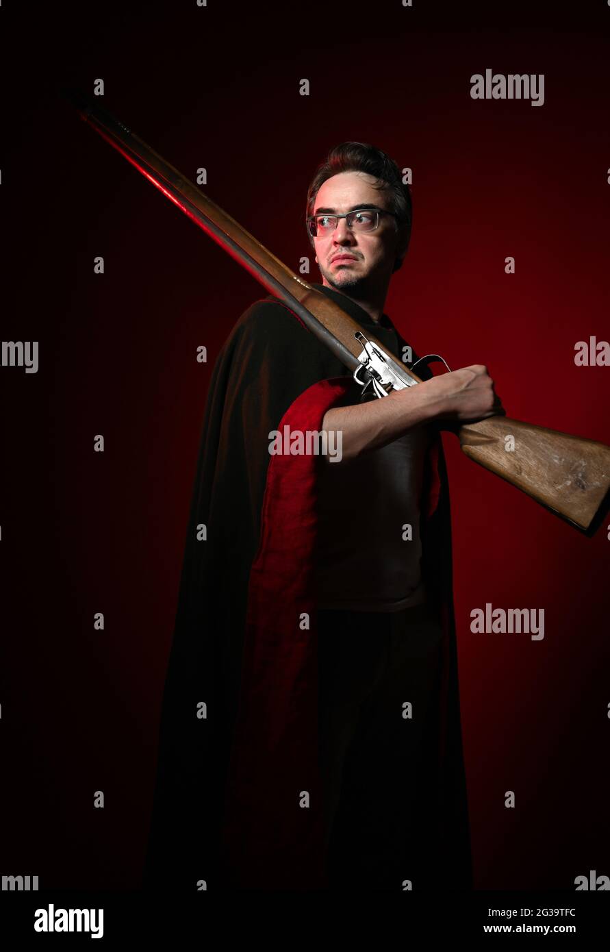 Soldier of past times in cape at night marching with his rifle slung ...