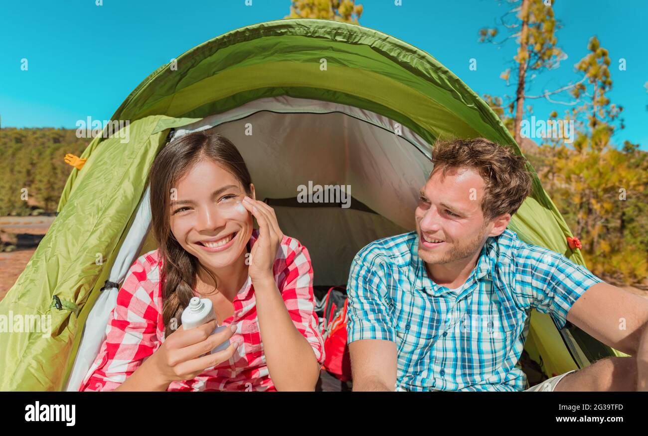 Man putting suntan lotion young woman hi-res stock photography and ...